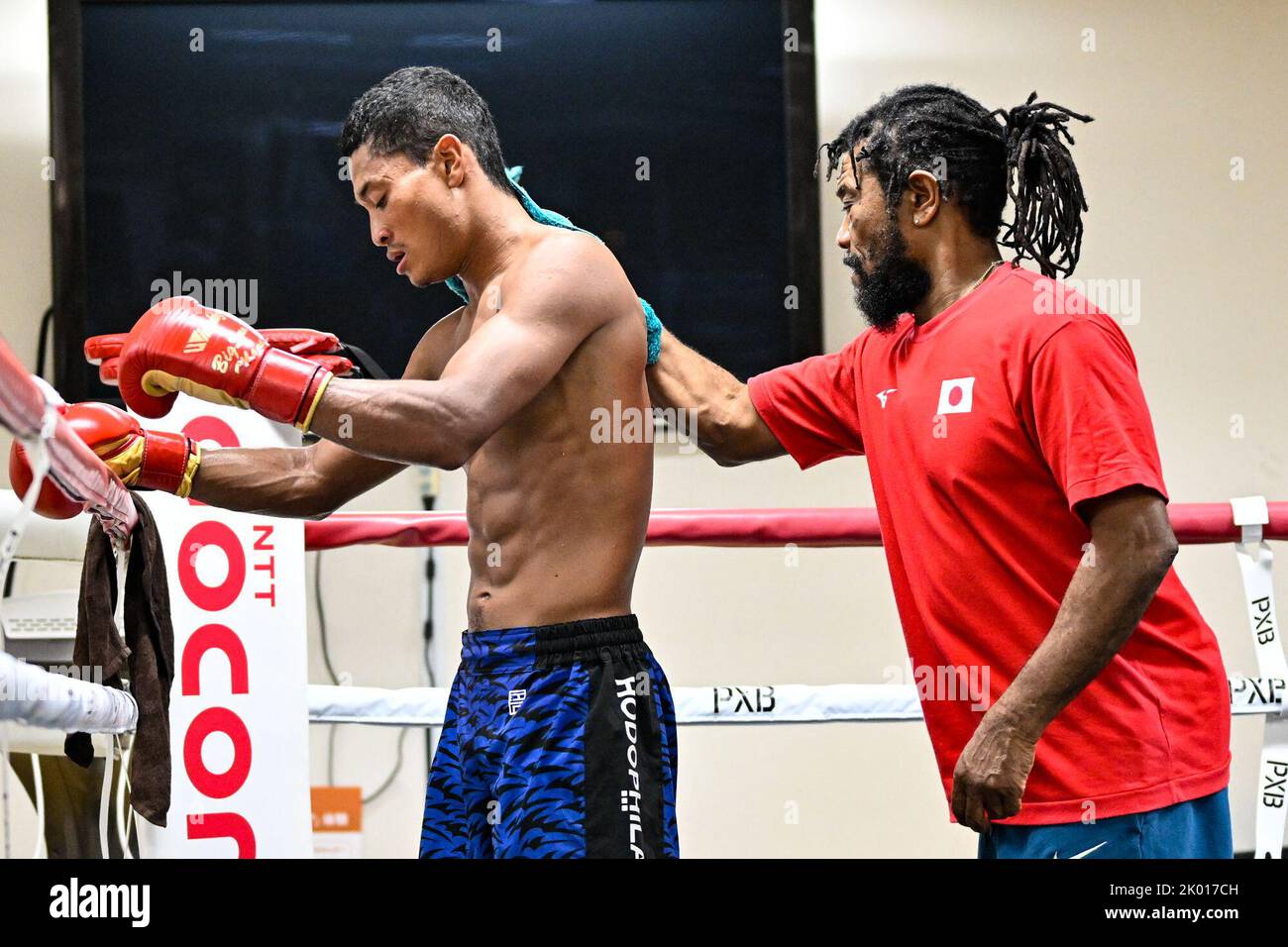 Andy Hiraoka (L) of Japan and his his trainer and father Justice Codjoe ...