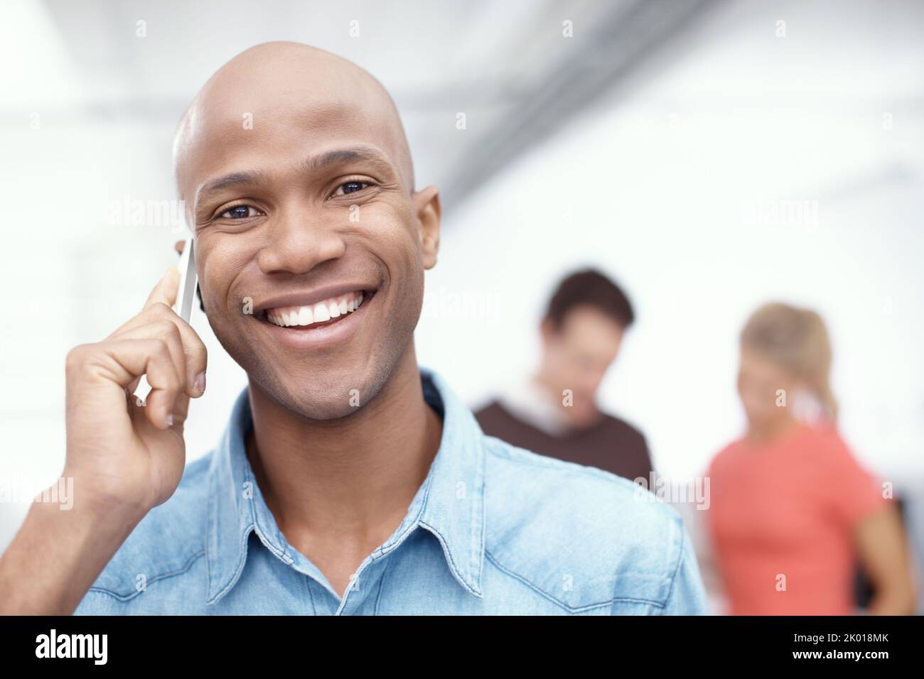 Taking a client call. Portrait of a young businessman talking on his ...