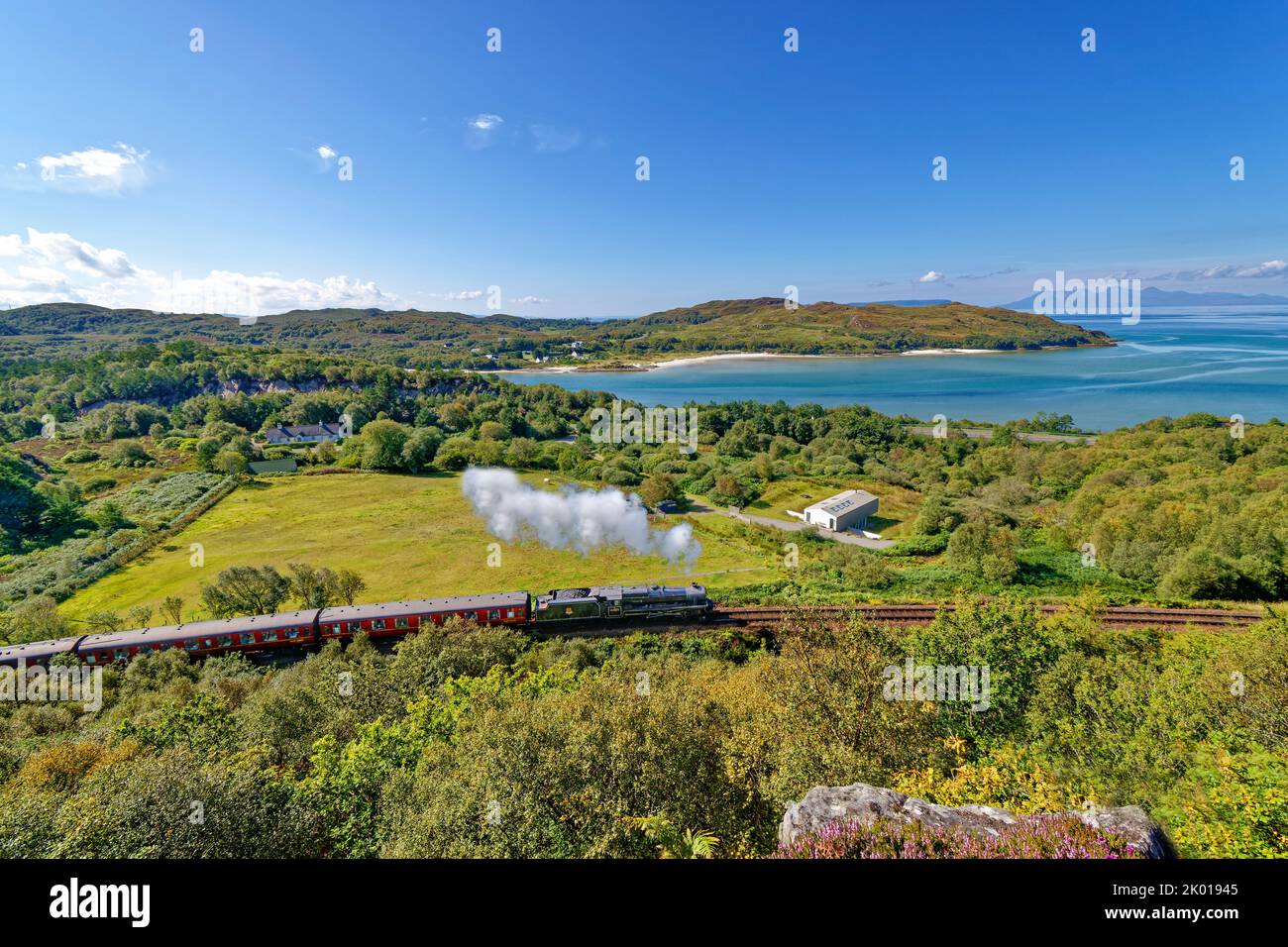 JACOBITE STEAM TRAIN ARRIVING AT MORAR BAY IN SUMMER WITH THE BLUE SEA ...