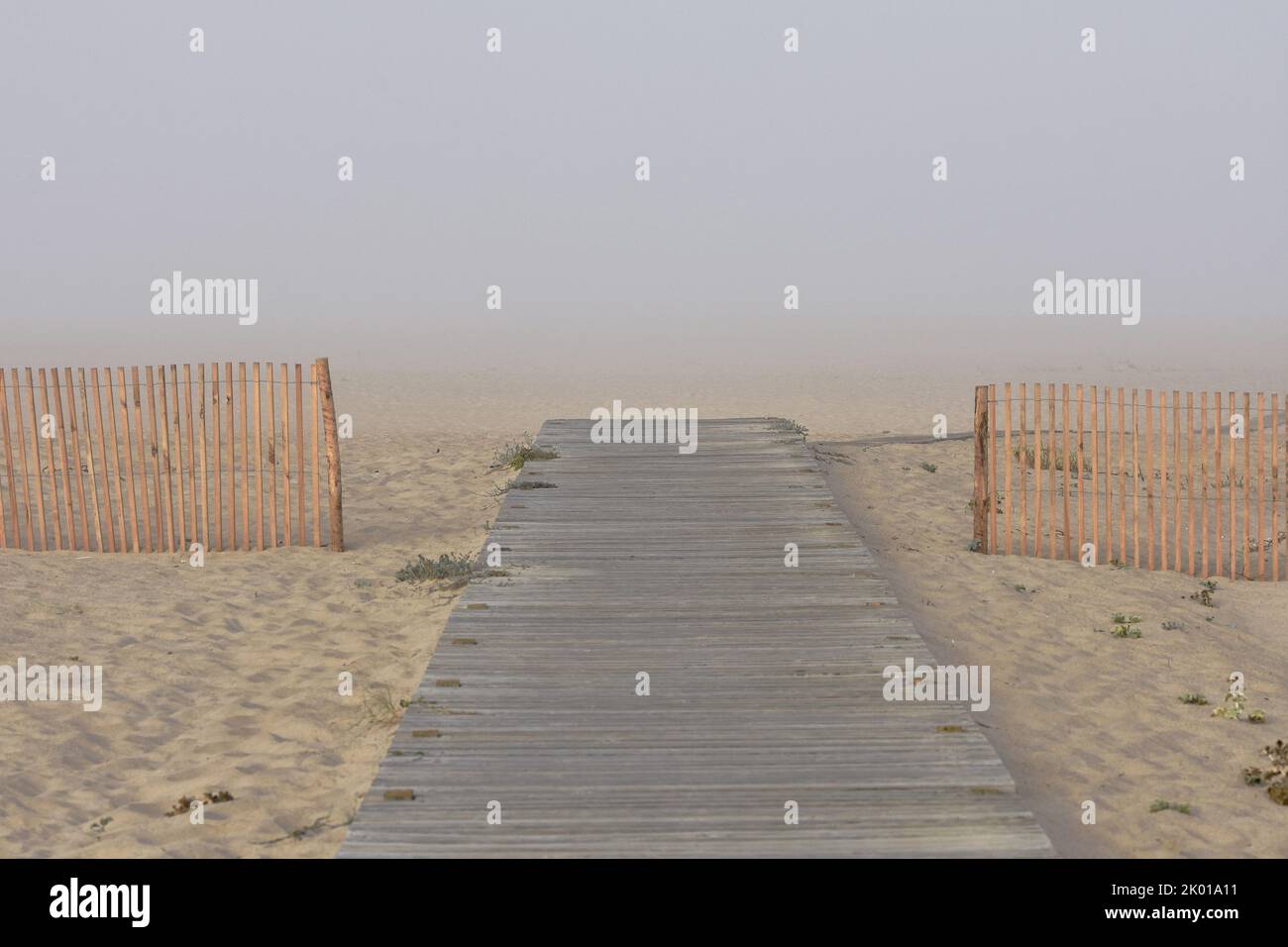 Wooden walkway in morning fog, Figueira da Foz beach in Portugal Stock ...