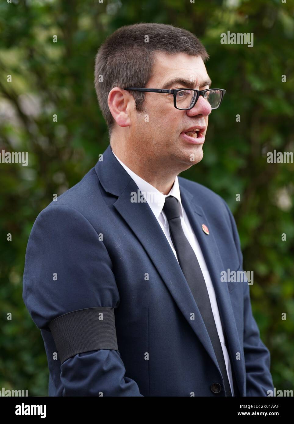 Arboretum lead Mark Ellis, wearing a black armband, speaks at the ...