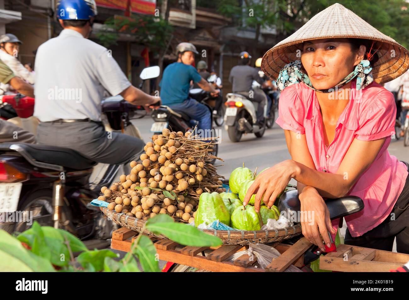Vietnamese lady wearing bamboo hat selling fruit and vegetables in the ...