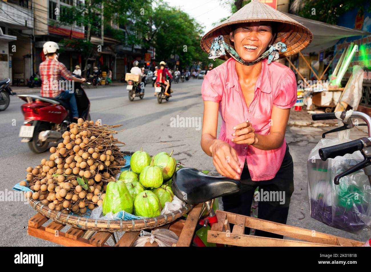 Vietnamese lady wearing bamboo hat selling fruit and vegetables in the ...