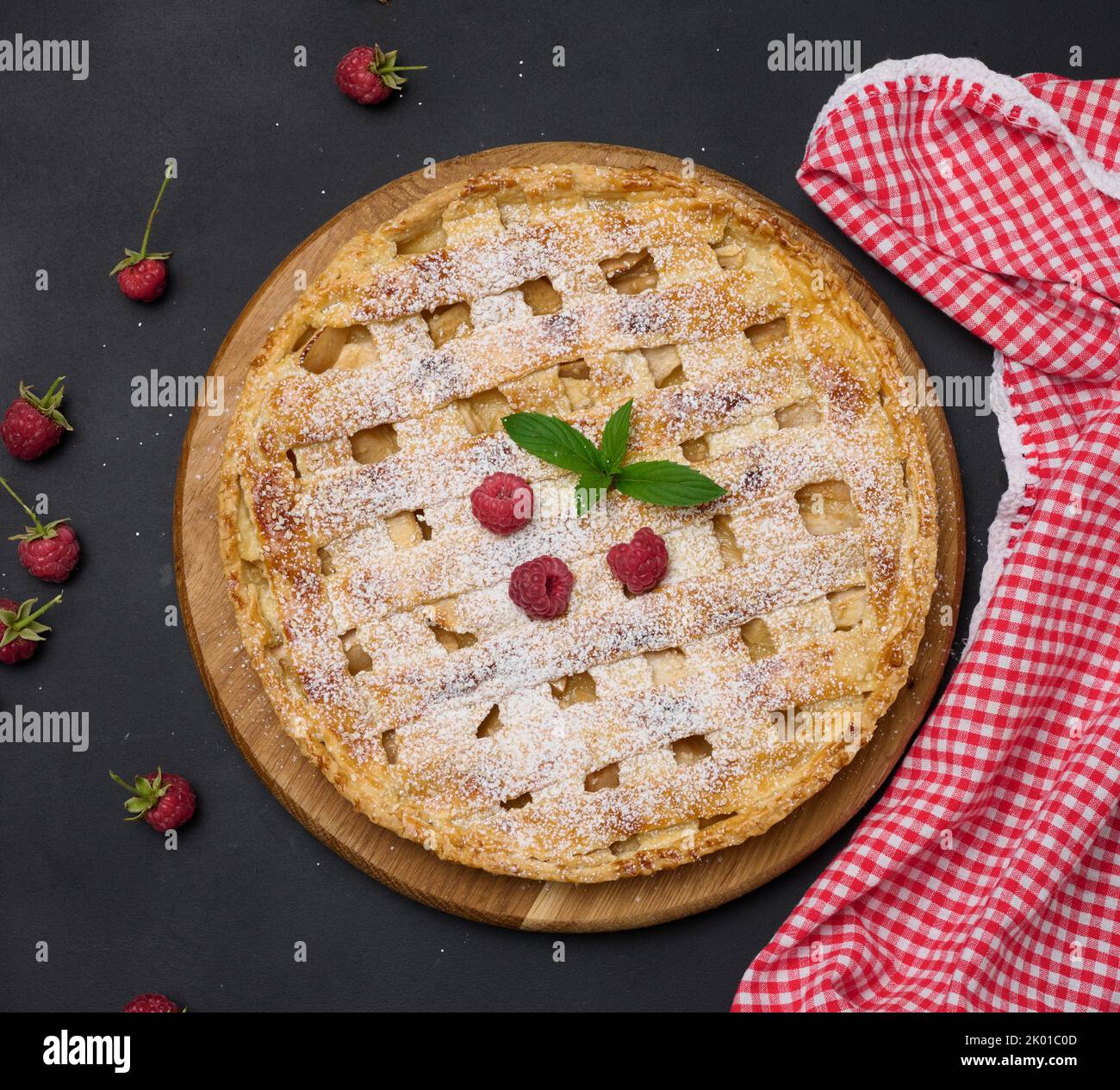 Round baked pie with apples and sprinkled with powdered sugar on a ...