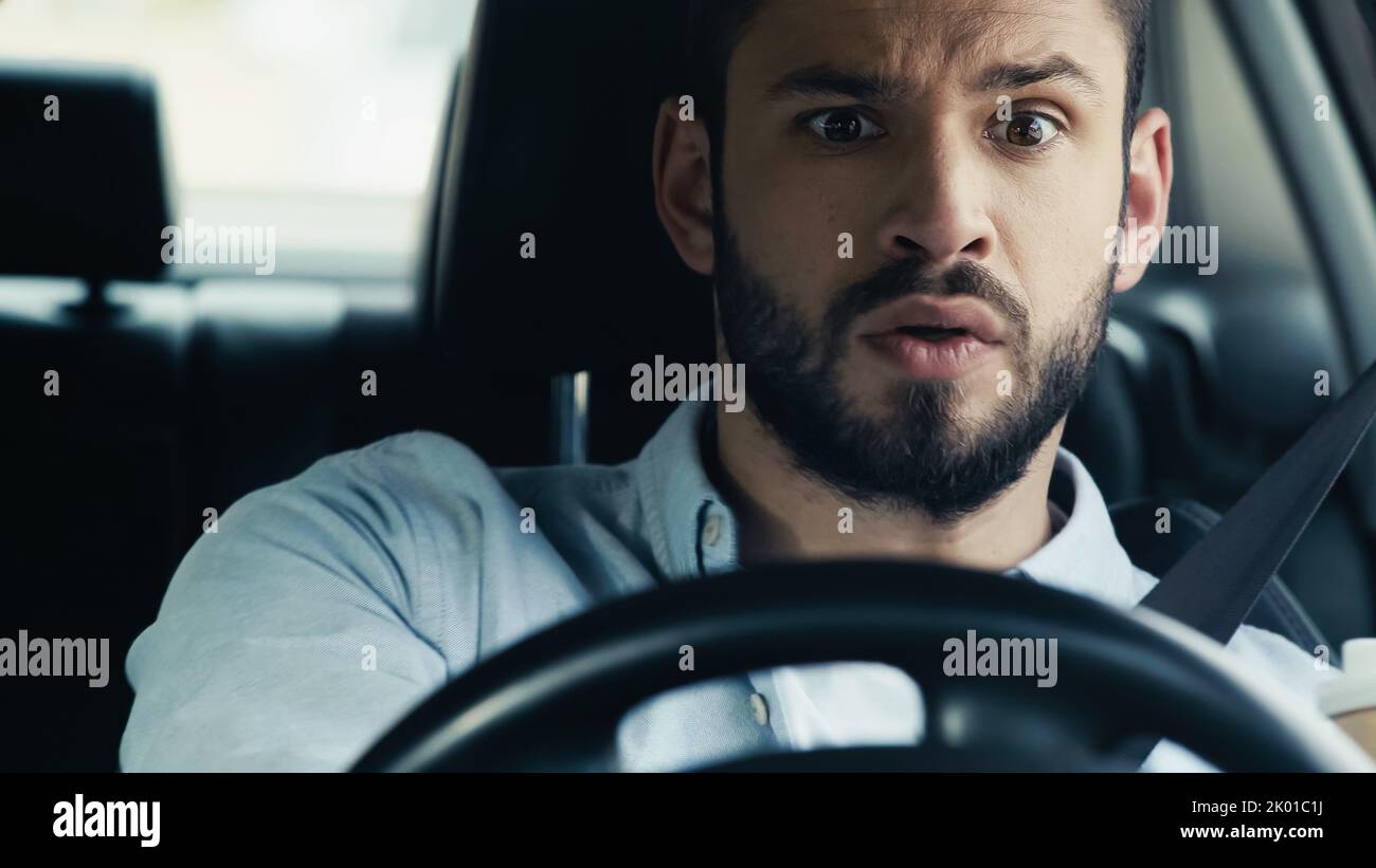 scared and worried man looking ahead while driving automobile,stock ...