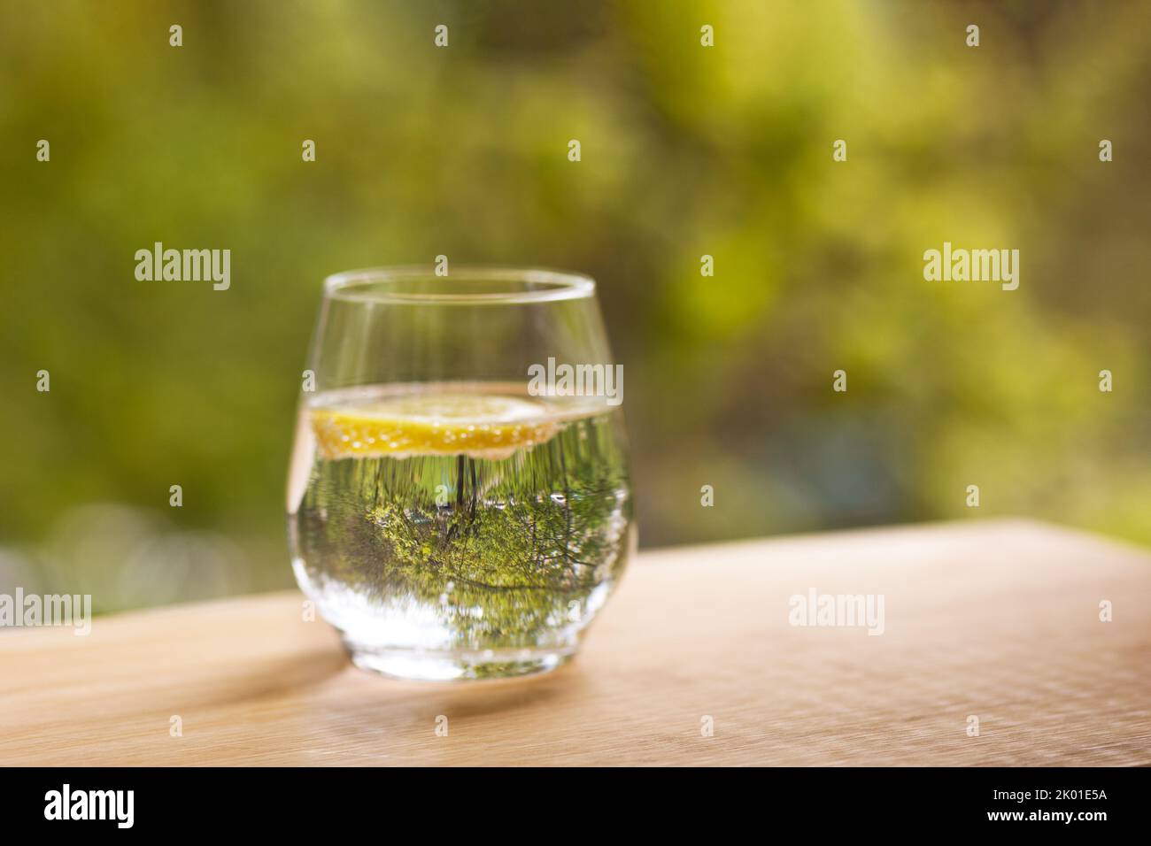 A glass of water with lemon on the window sill for healthy life, energy ...