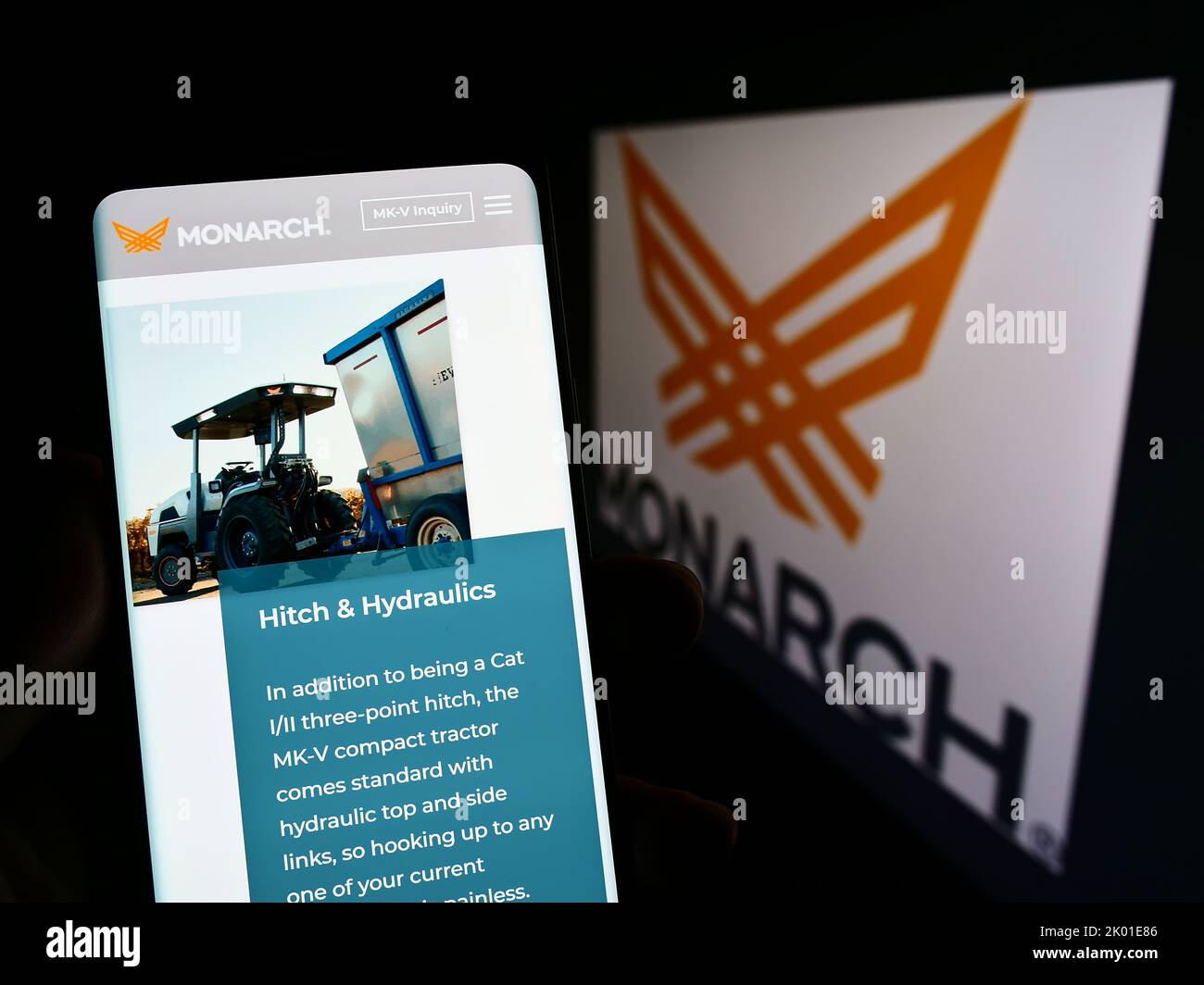 Person holding mobile phone with webpage of company Zimeno Inc ...