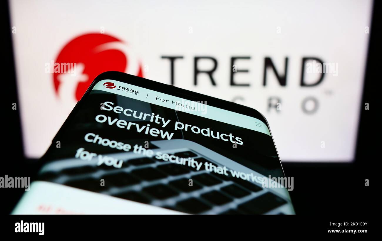 Mobile phone with website of cybersecurity company Trend Micro Inc. on screen in front of ...