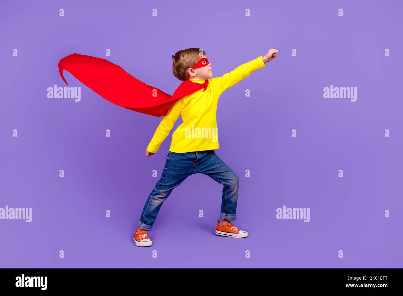 Full length photo of funky cool small son wear red mantle wind blowing ...