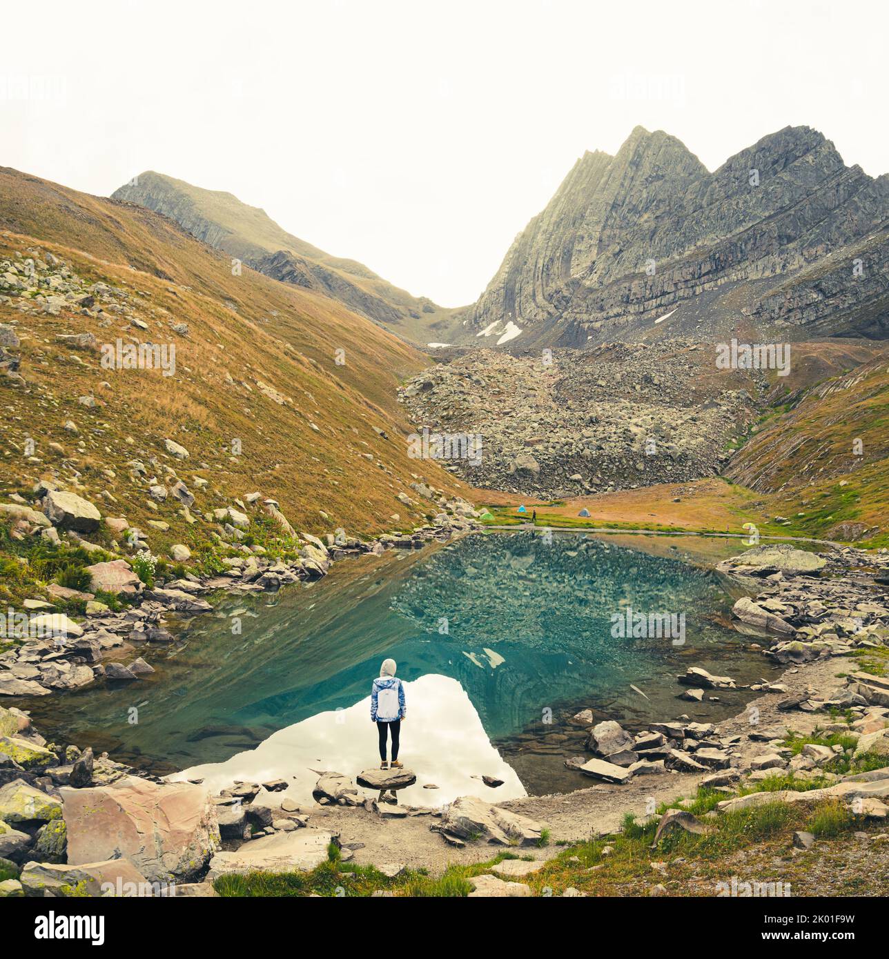 Static view tourist woman stand by Udziro lake viewpoint watch snow ...
