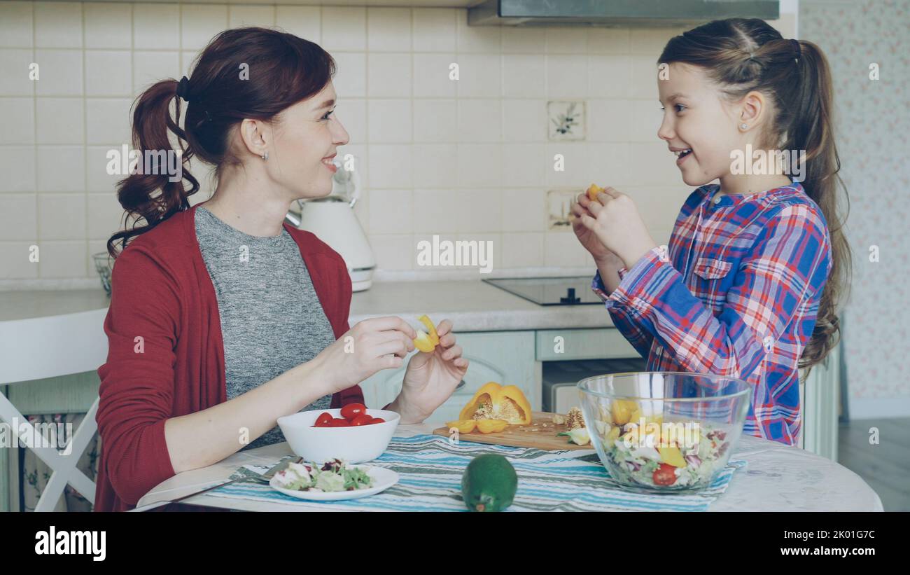 Happy family of young mother and cute cheerful daughter have fun ...