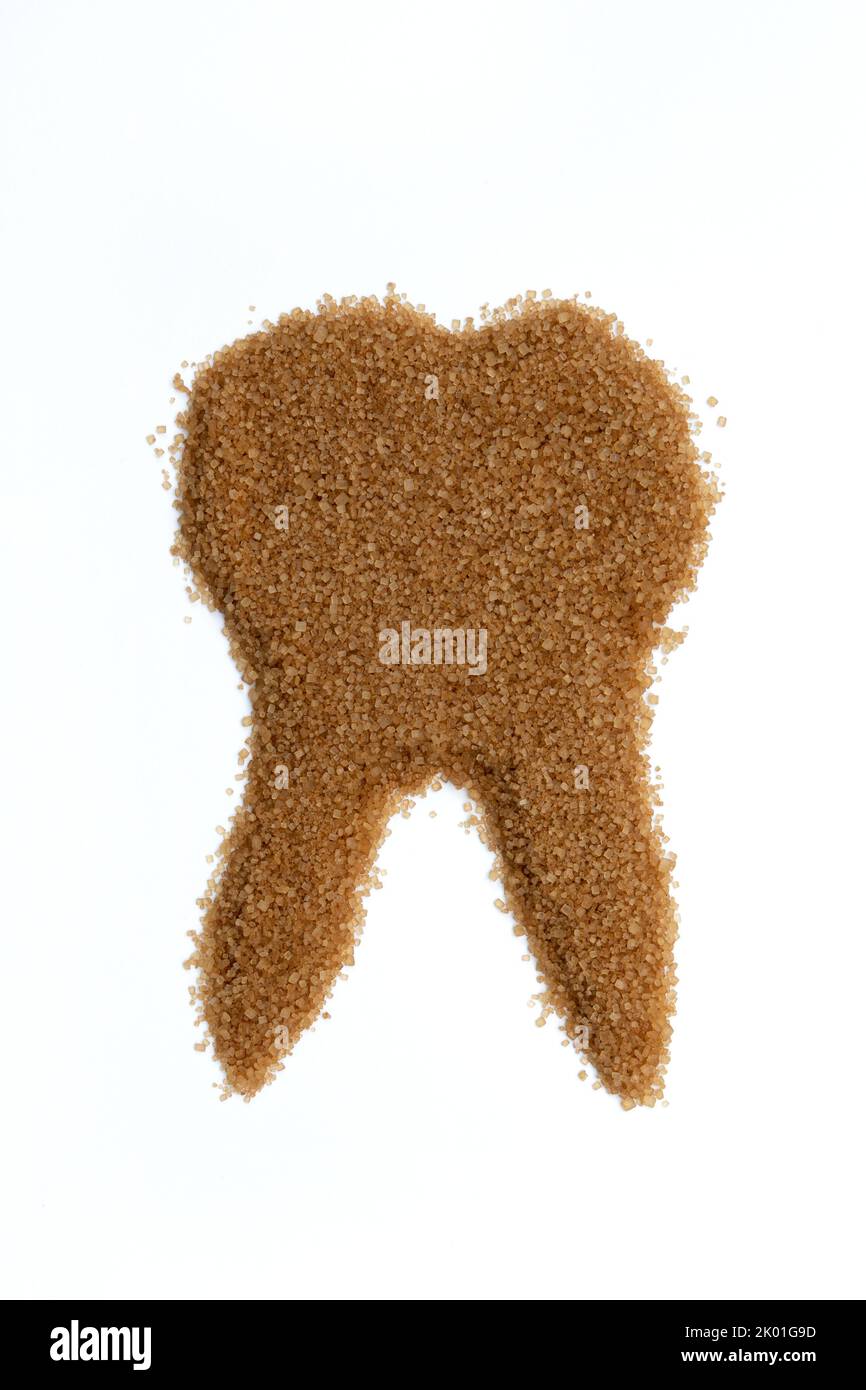 top view of unrefined natural brown sugar is laid out in form of tooth ...