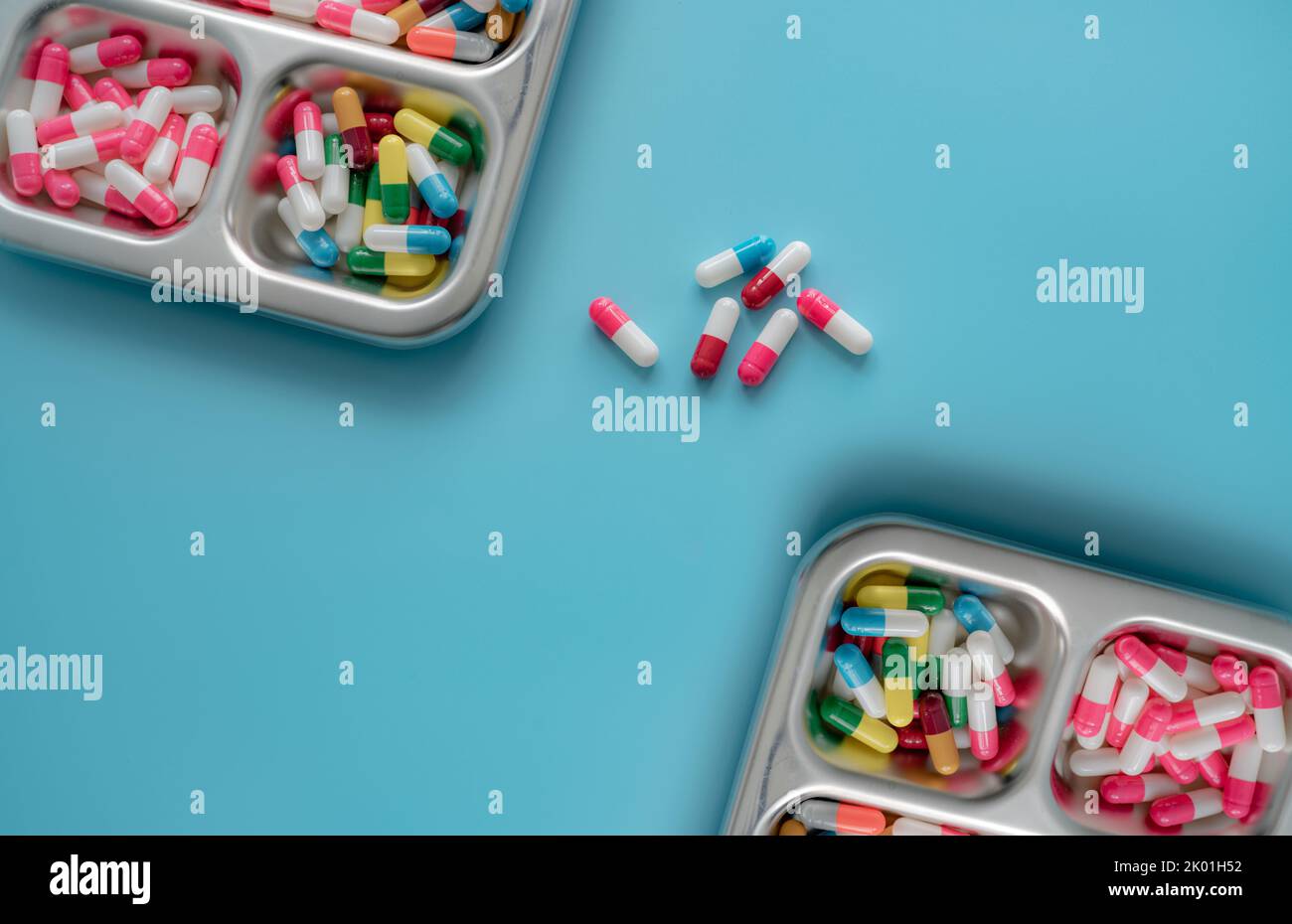 High angle view of multi-colored antibiotic capsule pills on stainless ...
