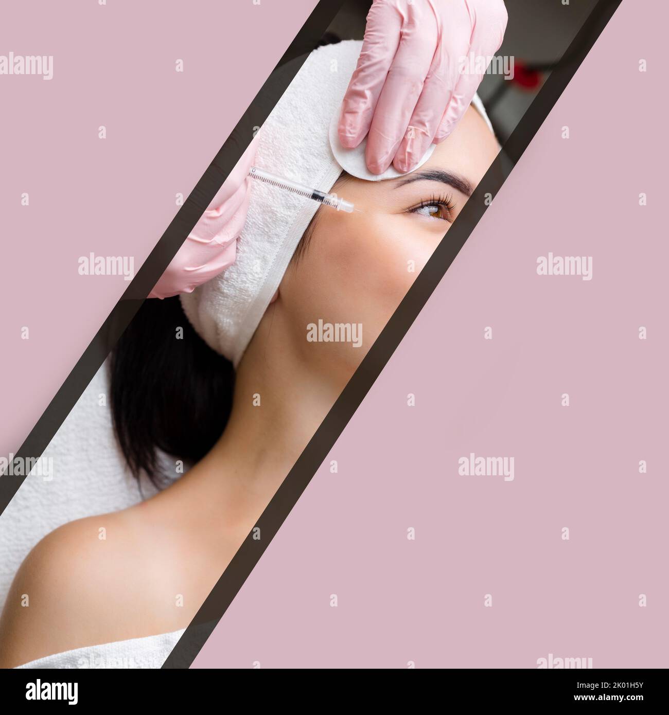 Close up of hands of young cosmetologist injecting botox in female face ...