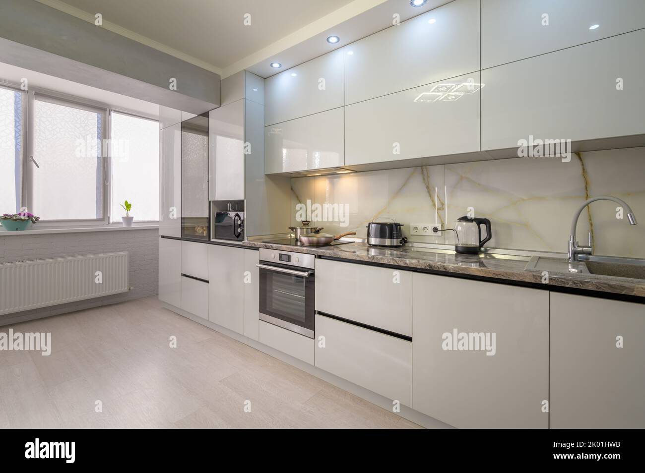 Interior of modern trendy white kitchen Stock Photo - Alamy