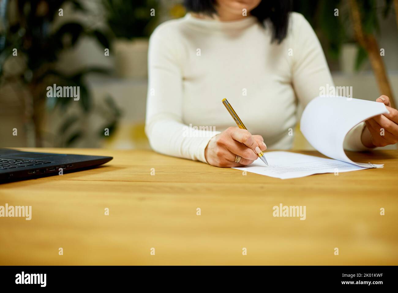 Woman hand signing a contract, making a deal with business partner ...