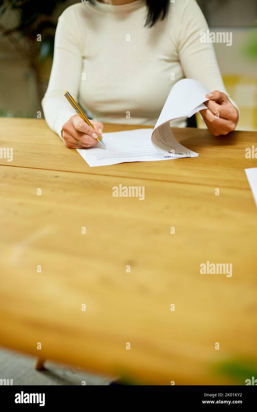 Woman hand signing a contract, making a deal with business partner ...