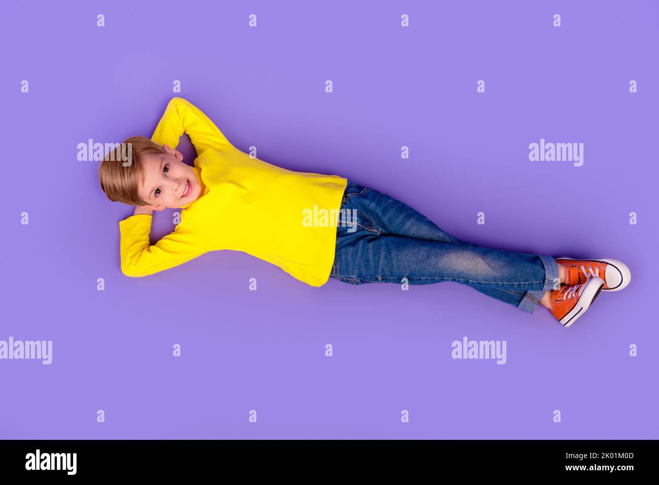 Full length photo top angle view of cheerful small son wear yellow ...