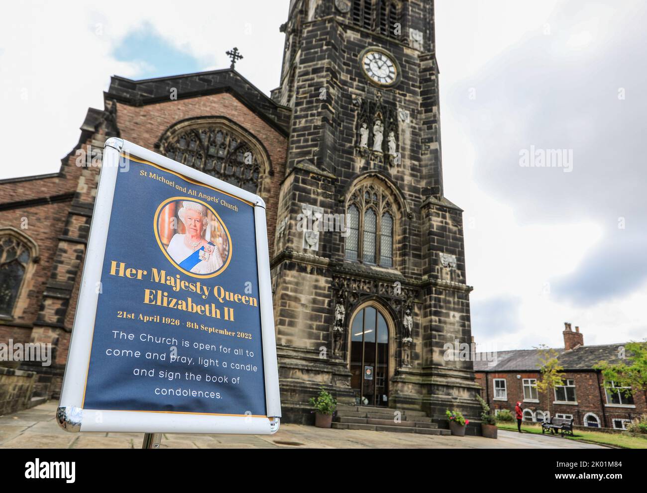 A sign of the Queen is on display outside St Michael and All Angels ...