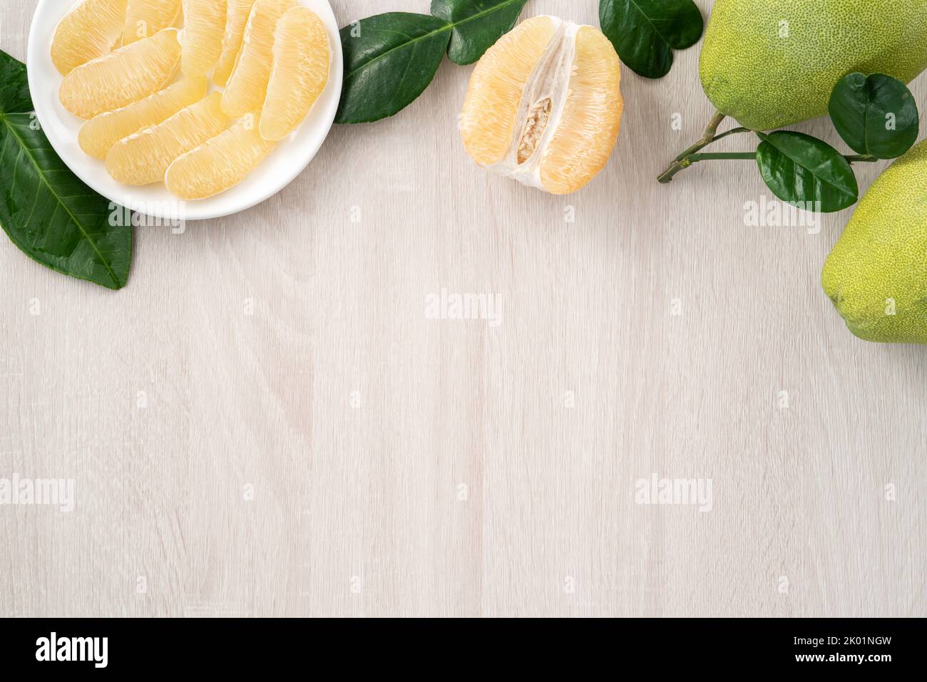Top view of fresh peeled pomelo on bright wooden table background for ...