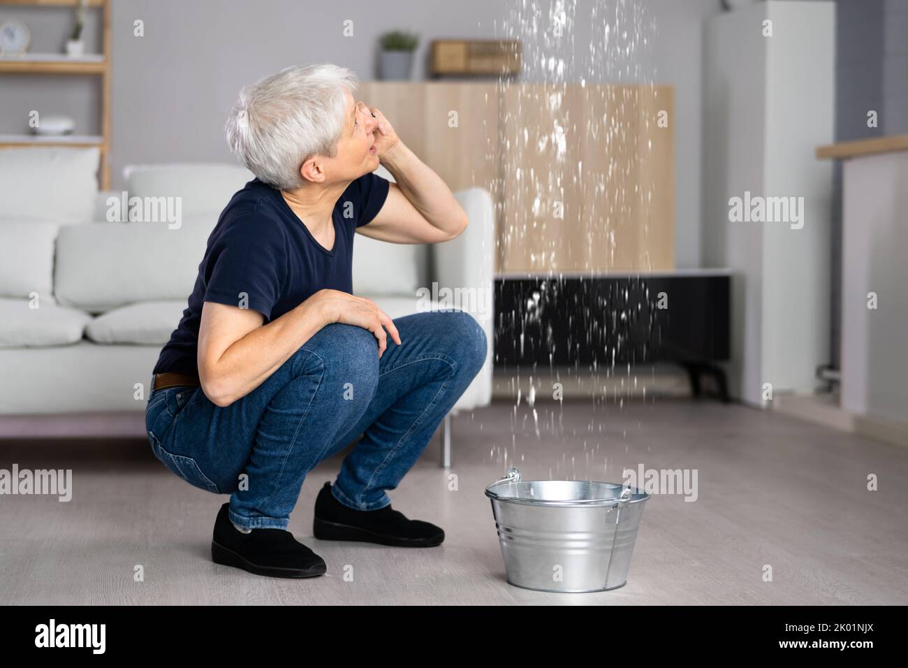 Worried Woman Calling Plumber To Fix Water Leak Stock Photo - Alamy