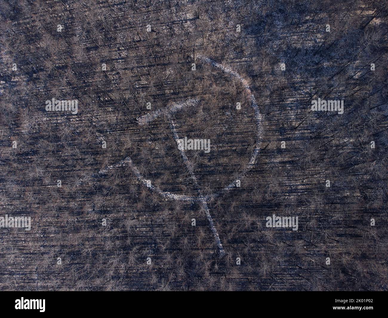 Stone Made Hammer and Sickle on Burned Ground Inside Fire Devastated ...