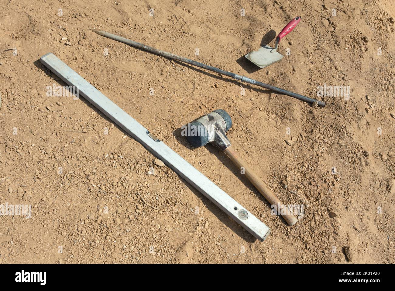 detail of spirit level, plastic hammer, hand trowel and iron stick at ...