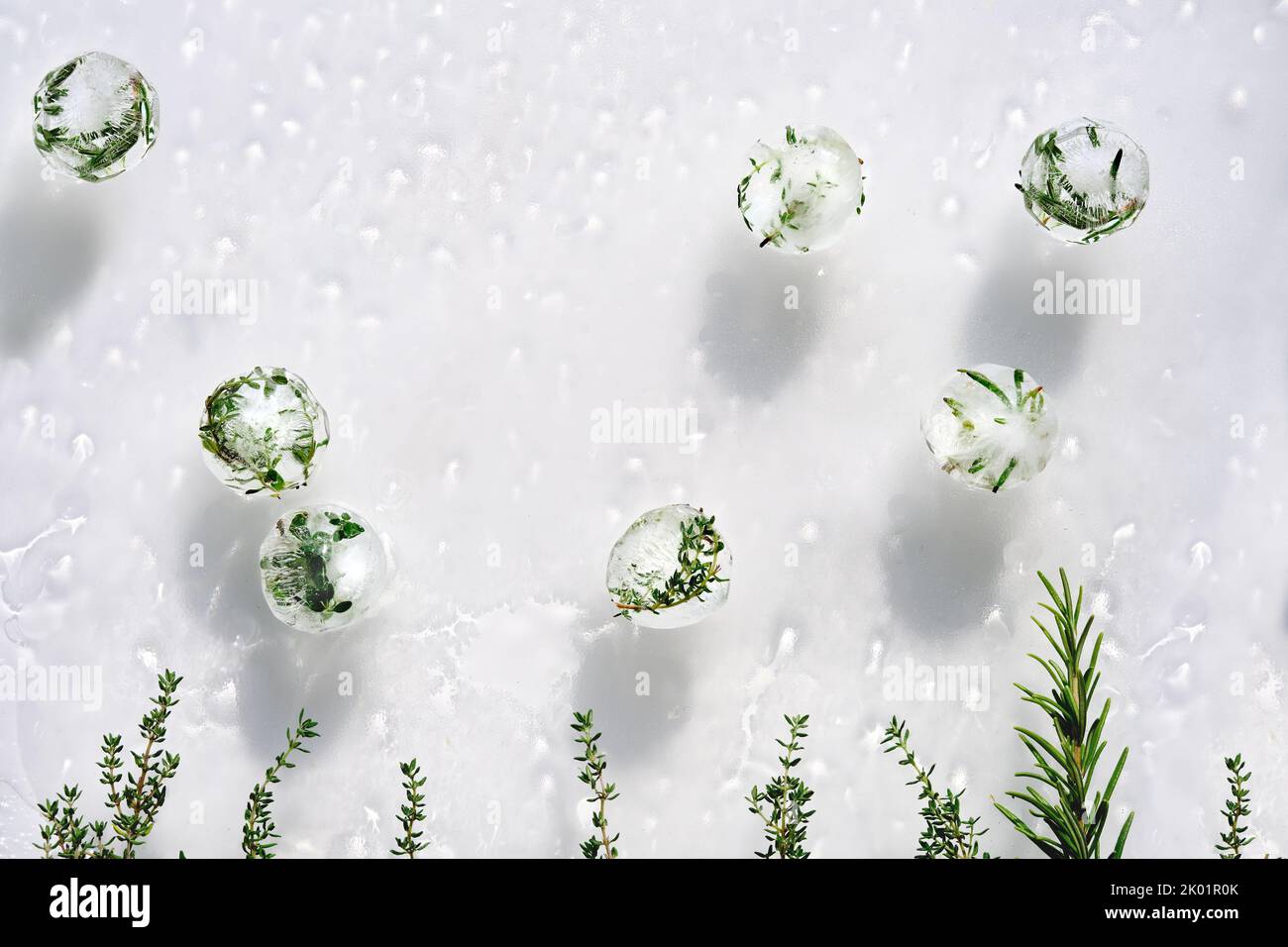 Wet off white water background with melting balls of ice with frozen ...