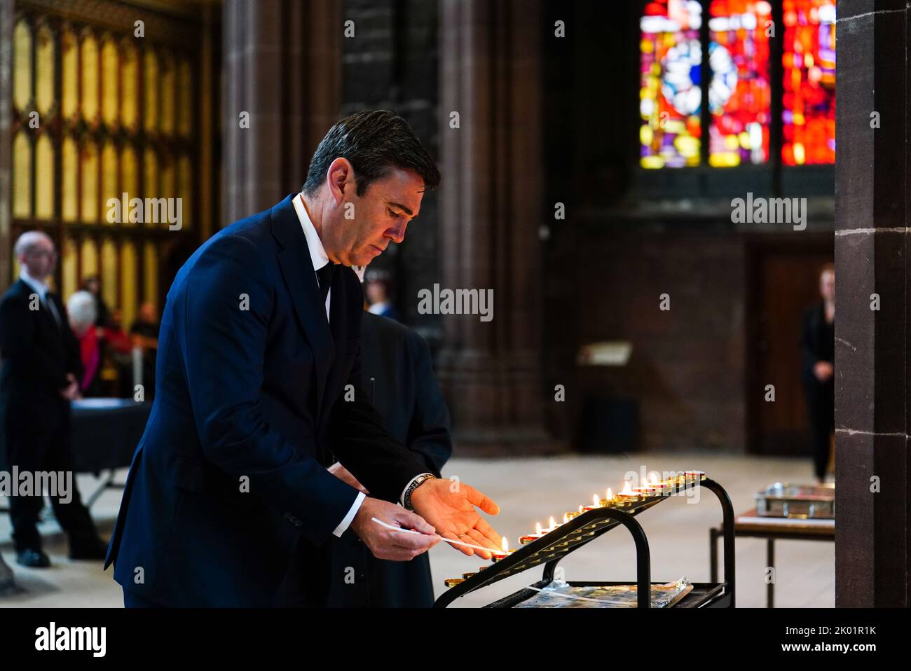 Andy Burnham, Mayor of Greater Manchester, lighting a candle at ...