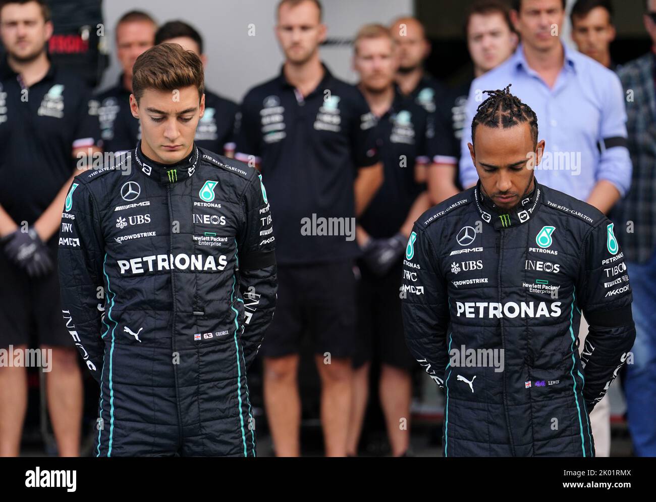 Mercedes' Lewis Hamilton (right) and George Russell stand during a ...
