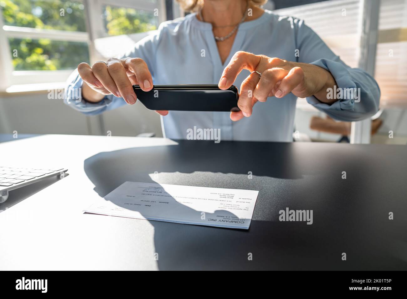 Remote Check Deposit Taking Photo With Mobile Phone Stock Photo - Alamy