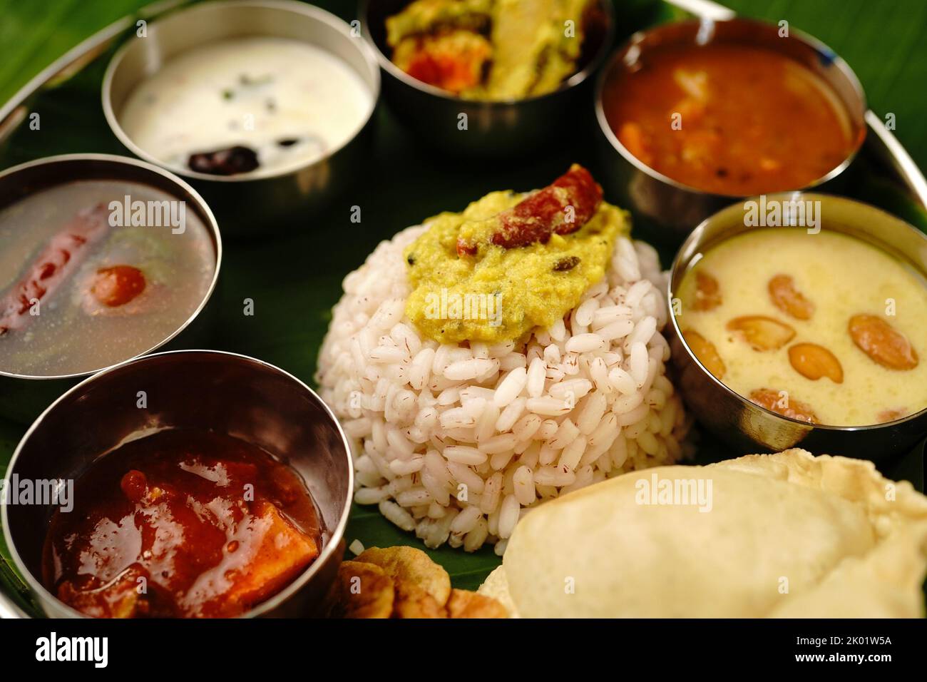 Kerala Ona sadya Onam feast - vegetarian thali served on a round plate ...