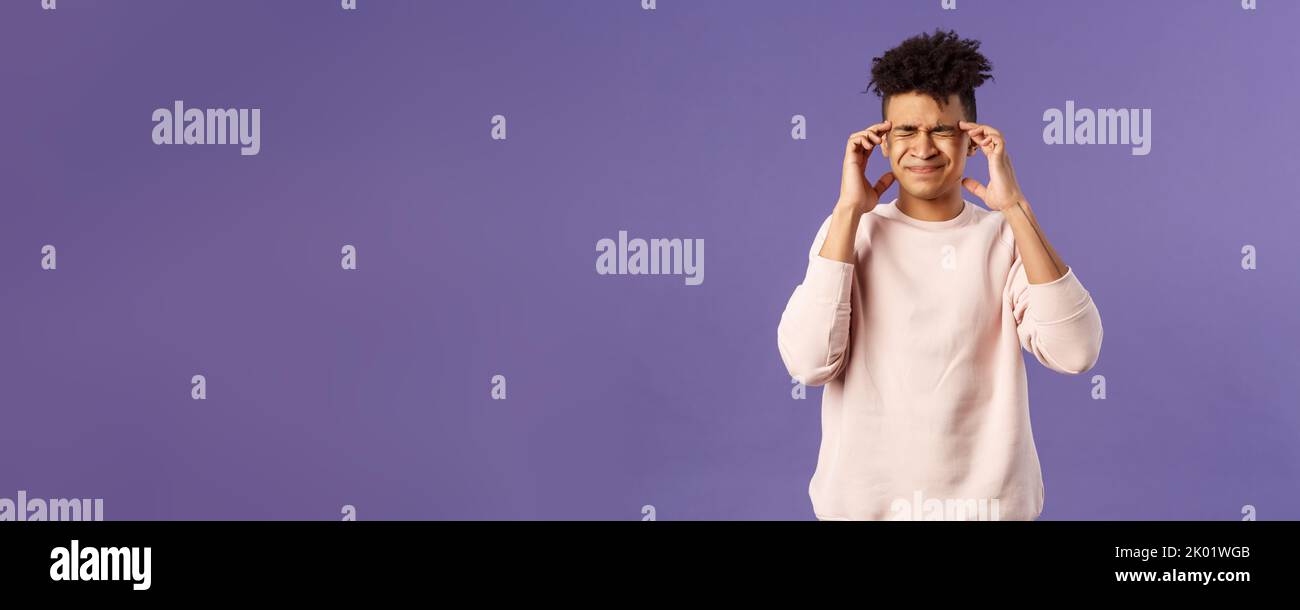 Portrait of intense, pressed young male student overworked, feel tired ...