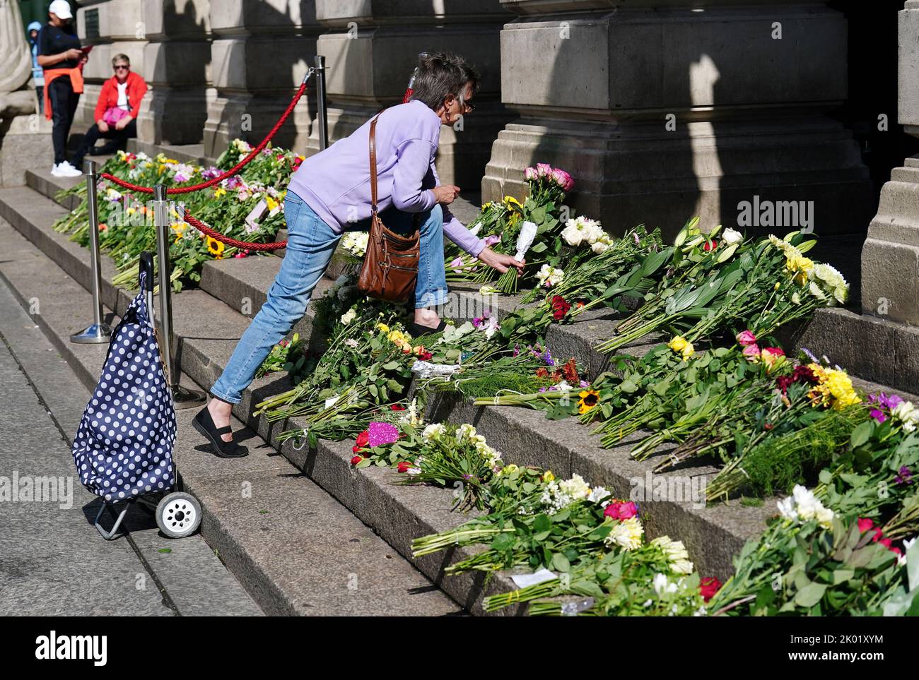A member of the public lays flowers outside Nottingham Council House ...