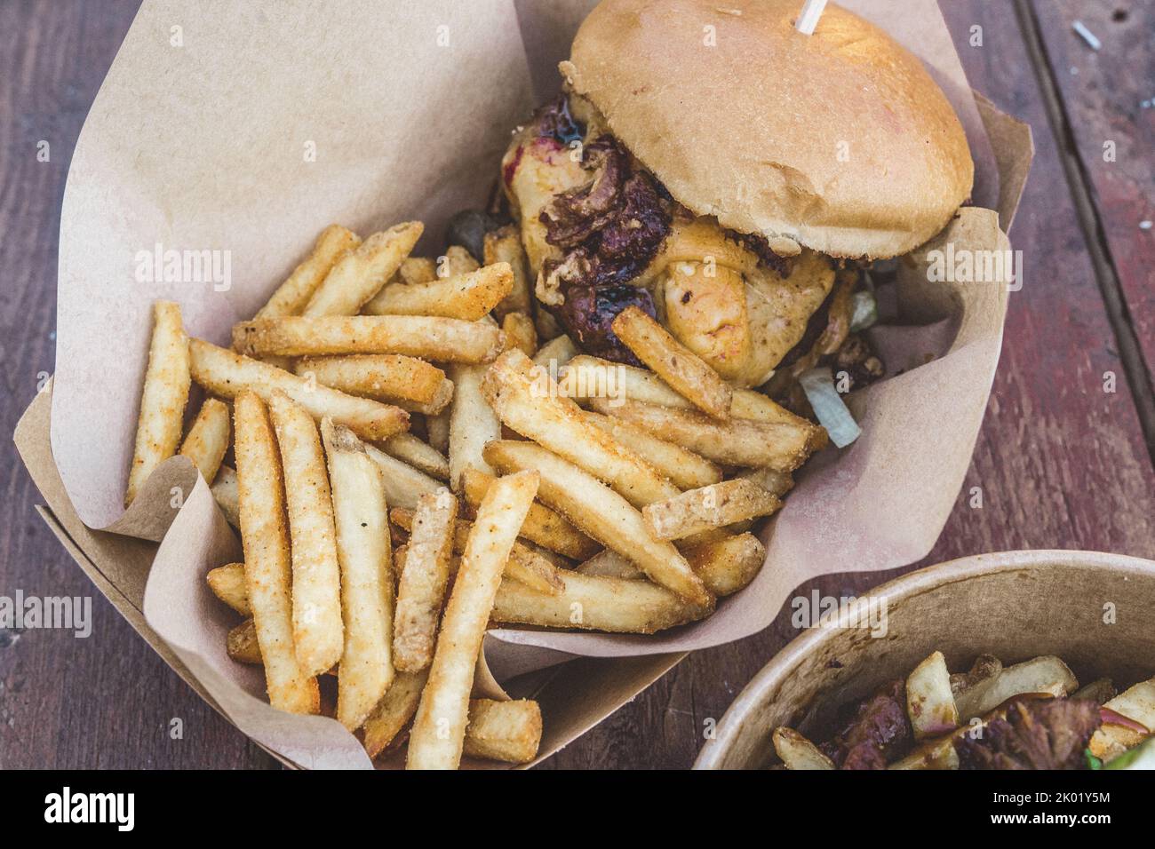 A burger with fries in a cardboard plate by the bonfire Stock Photo - Alamy
