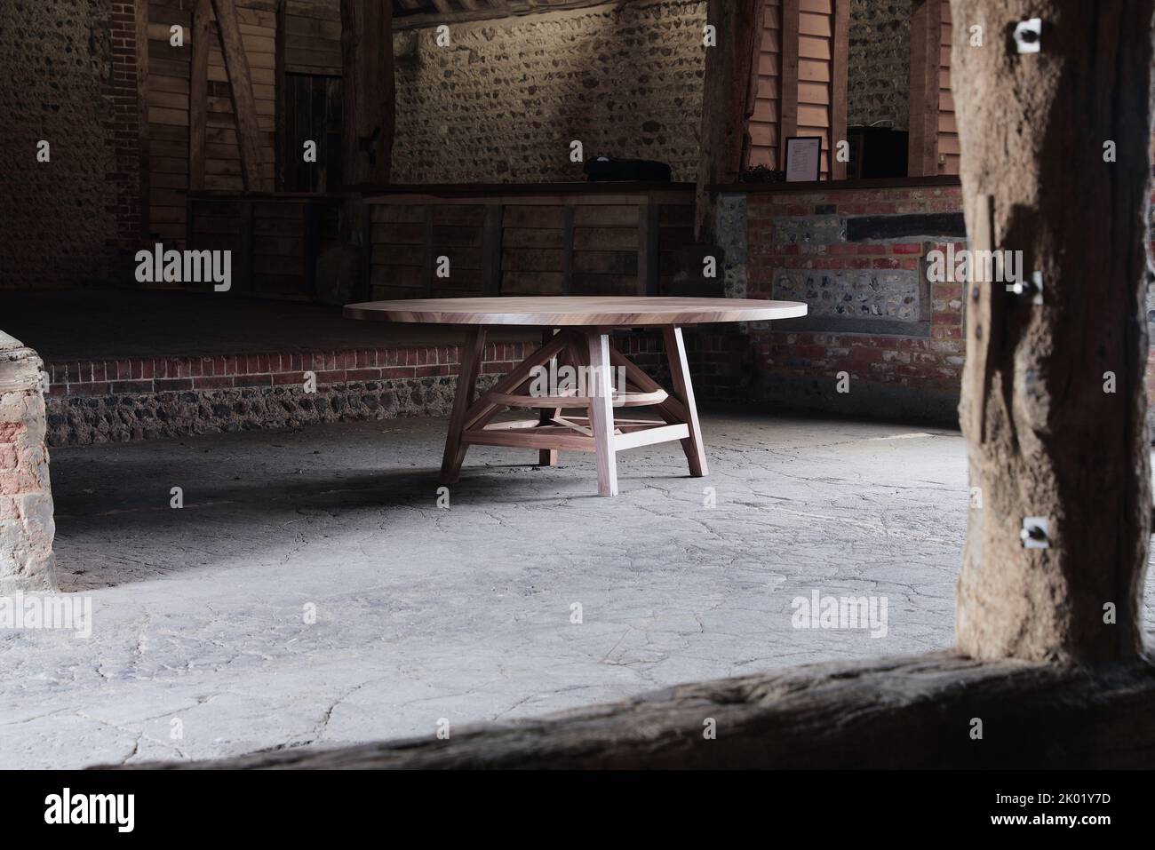 A simple wooden round table design idea Stock Photo - Alamy