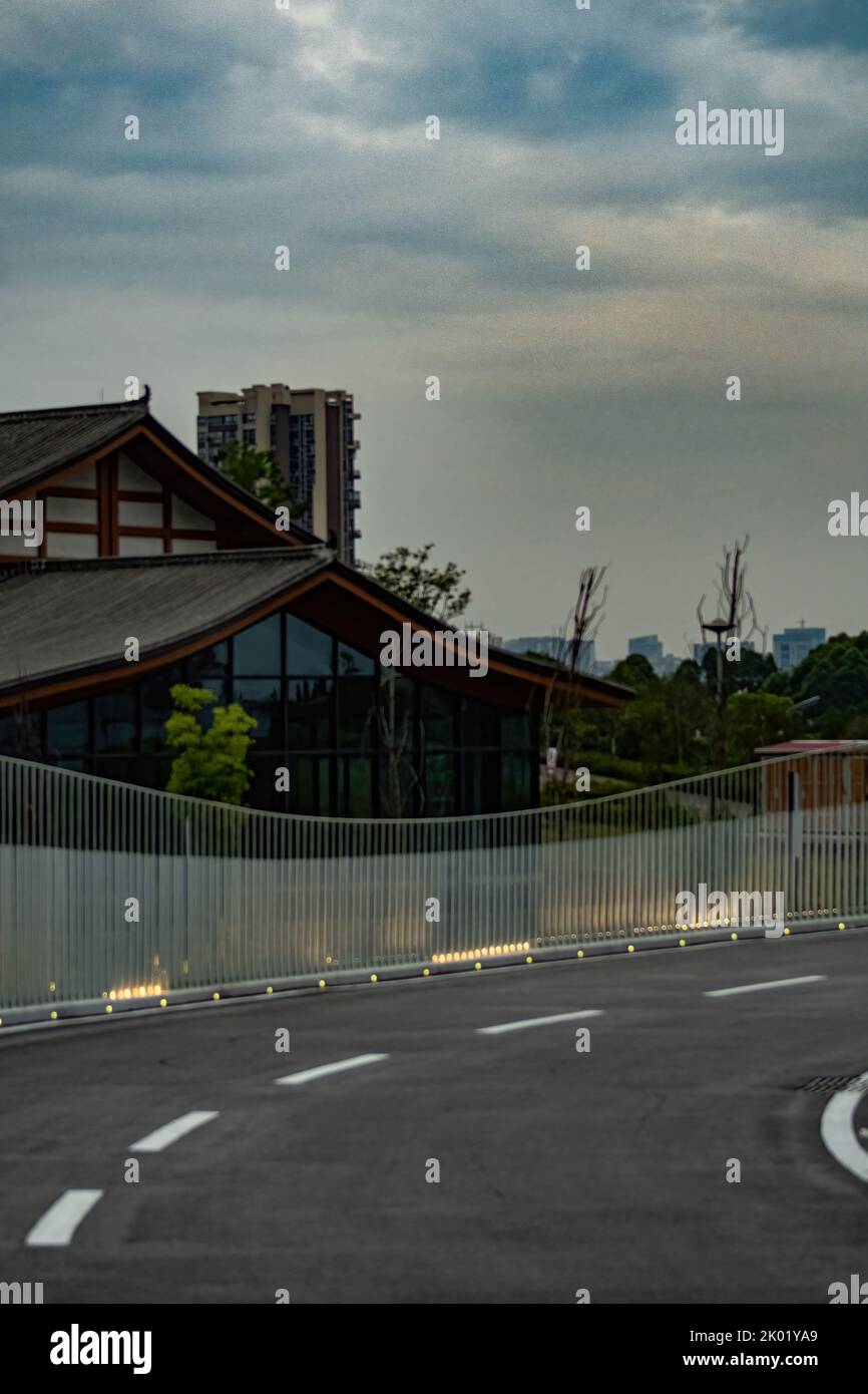 A modern house with glass facade near the empty street in Longquanyi ...