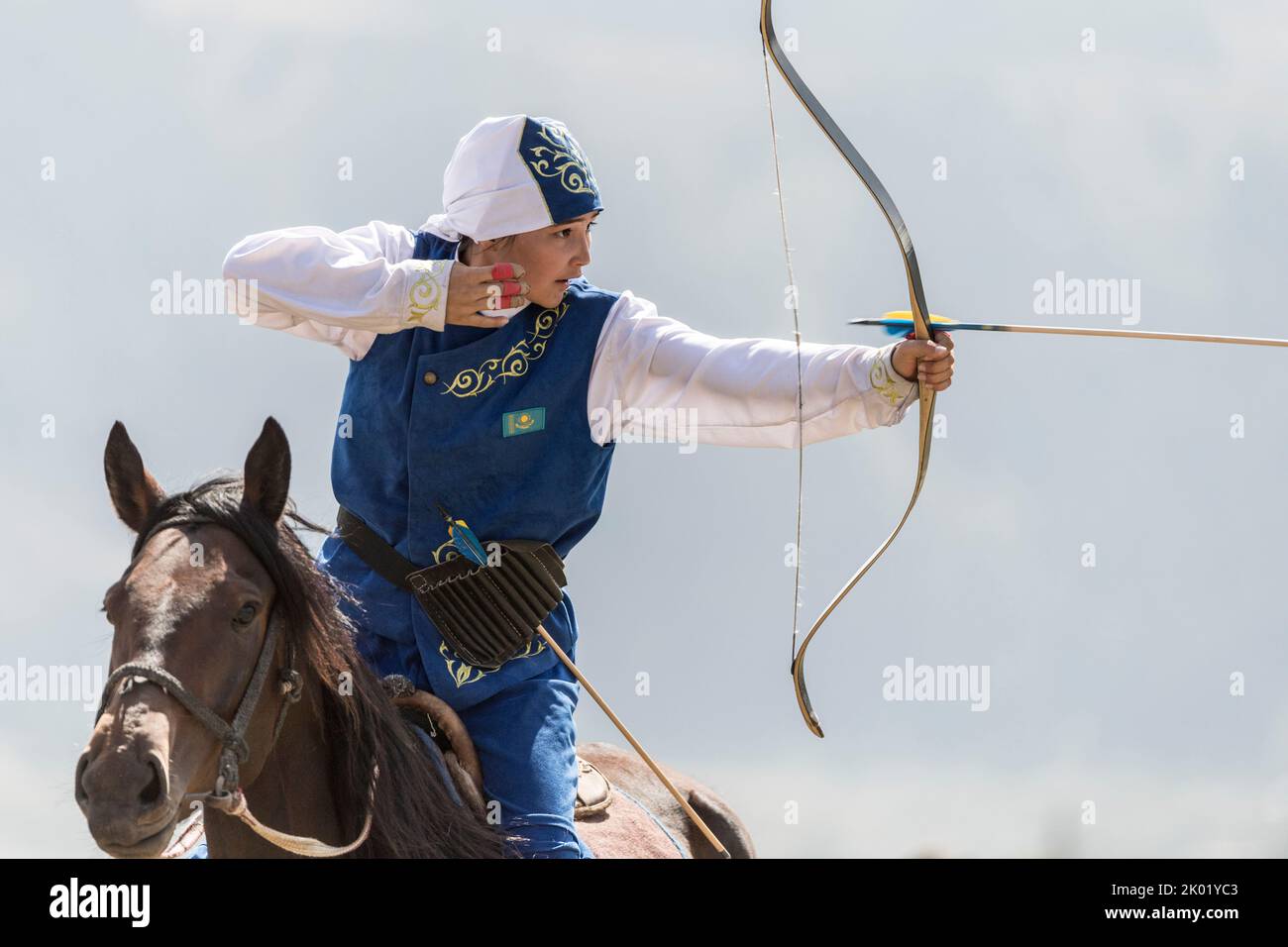 Female horseback archer releasing the arrow during a competition at the ...