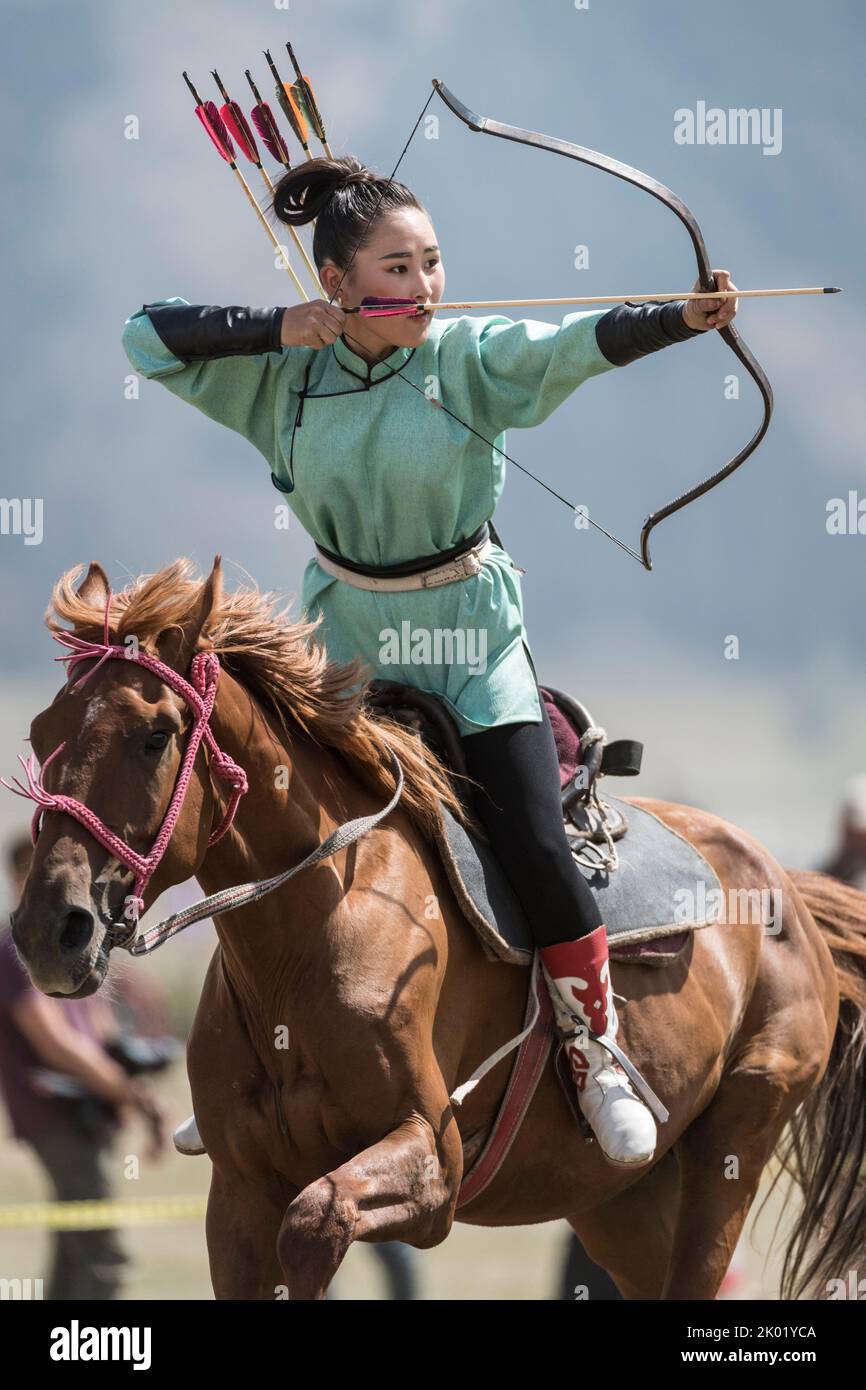Female horseback archer releasing the arrow during a competition at the ...
