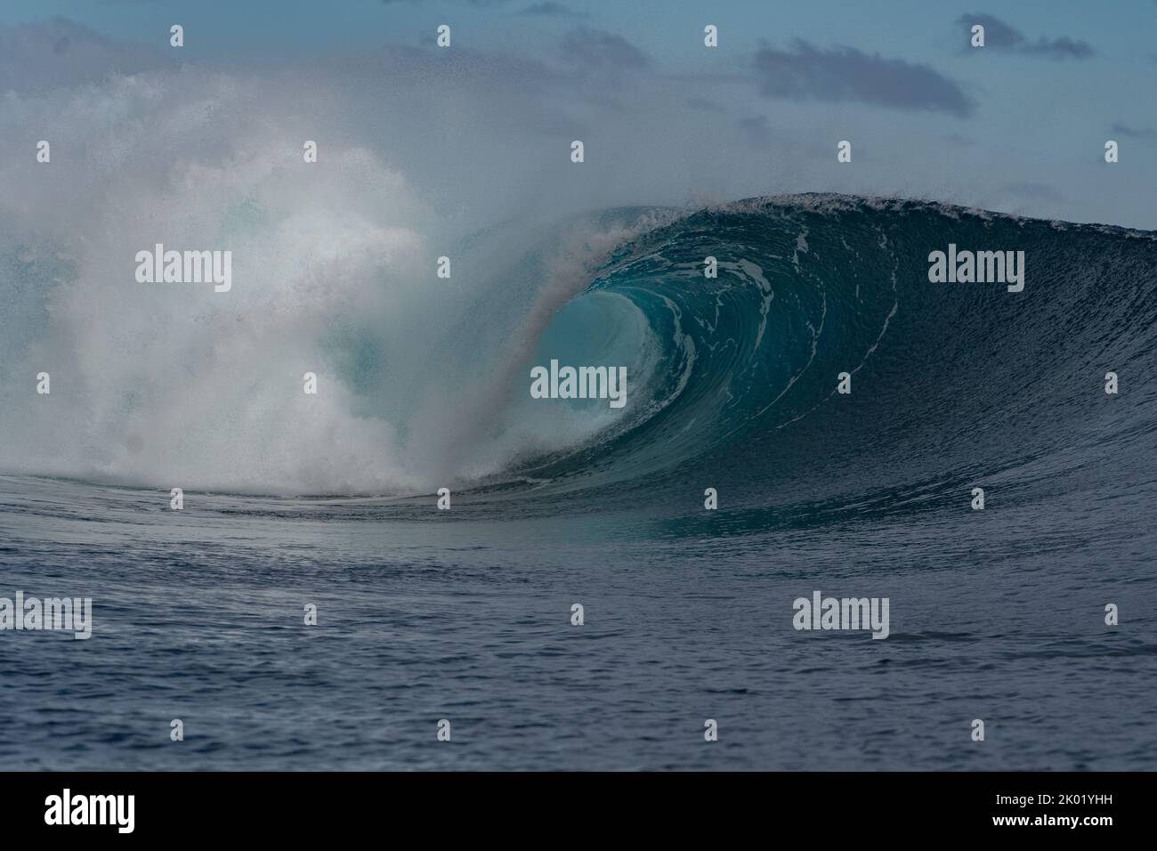 A beautiful shot of a huge blue wave in the ocean in Teahupoo village ...