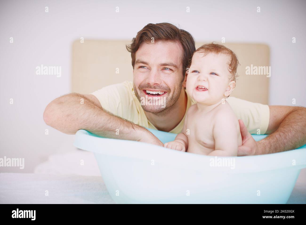 Hes such a doting father. A young father bonding with his baby daughter ...