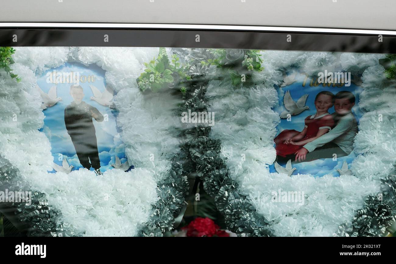 Floral tributes and photos placed in a hearse as the funeral service of ...