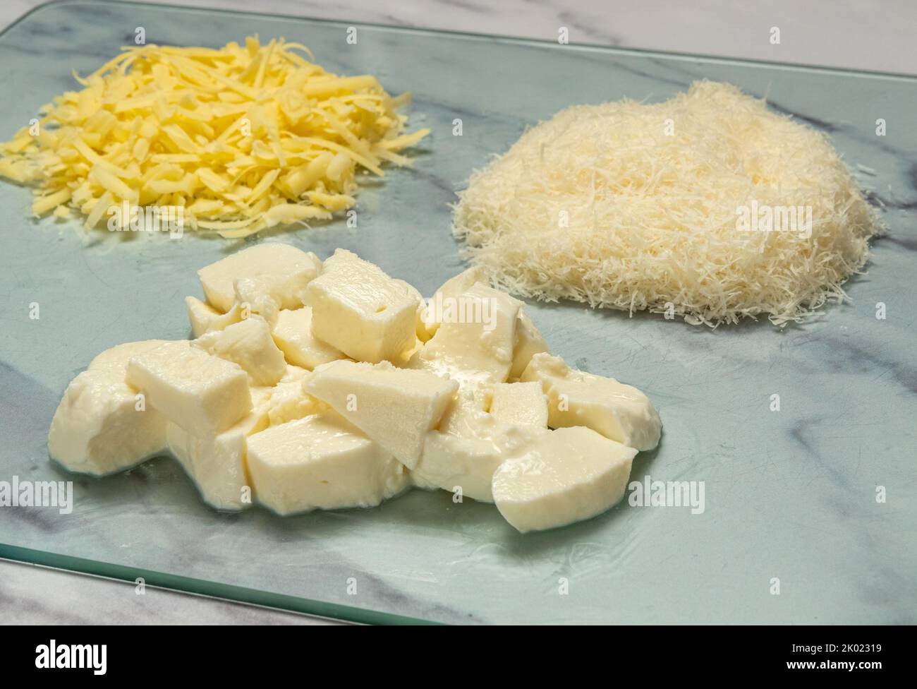 Mozzarella, parmesan and cheddar close up Stock Photo - Alamy