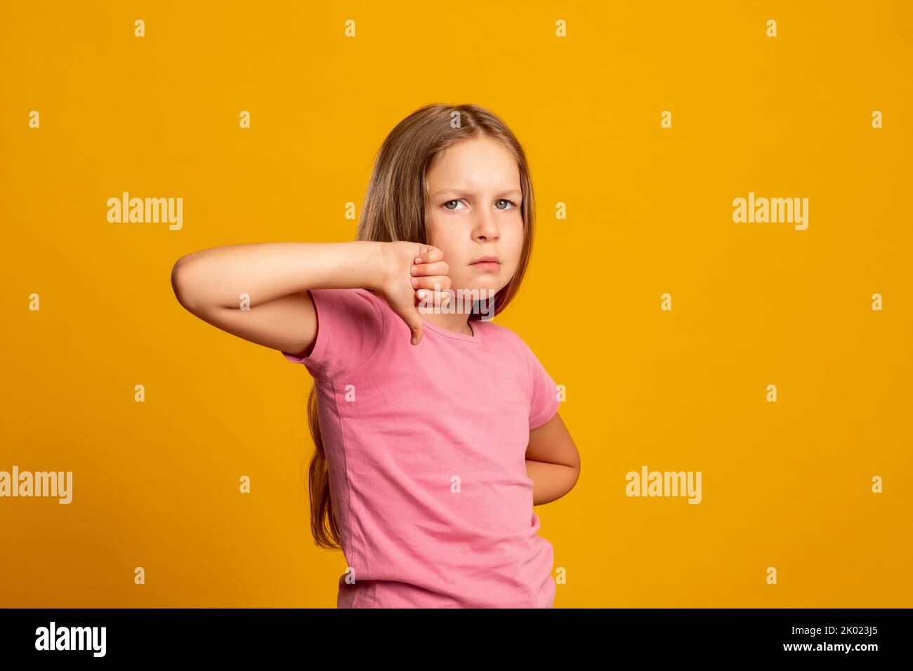 Dislike gesture. Disappointed child. Wrong choice. Bad idea. Sad young ...