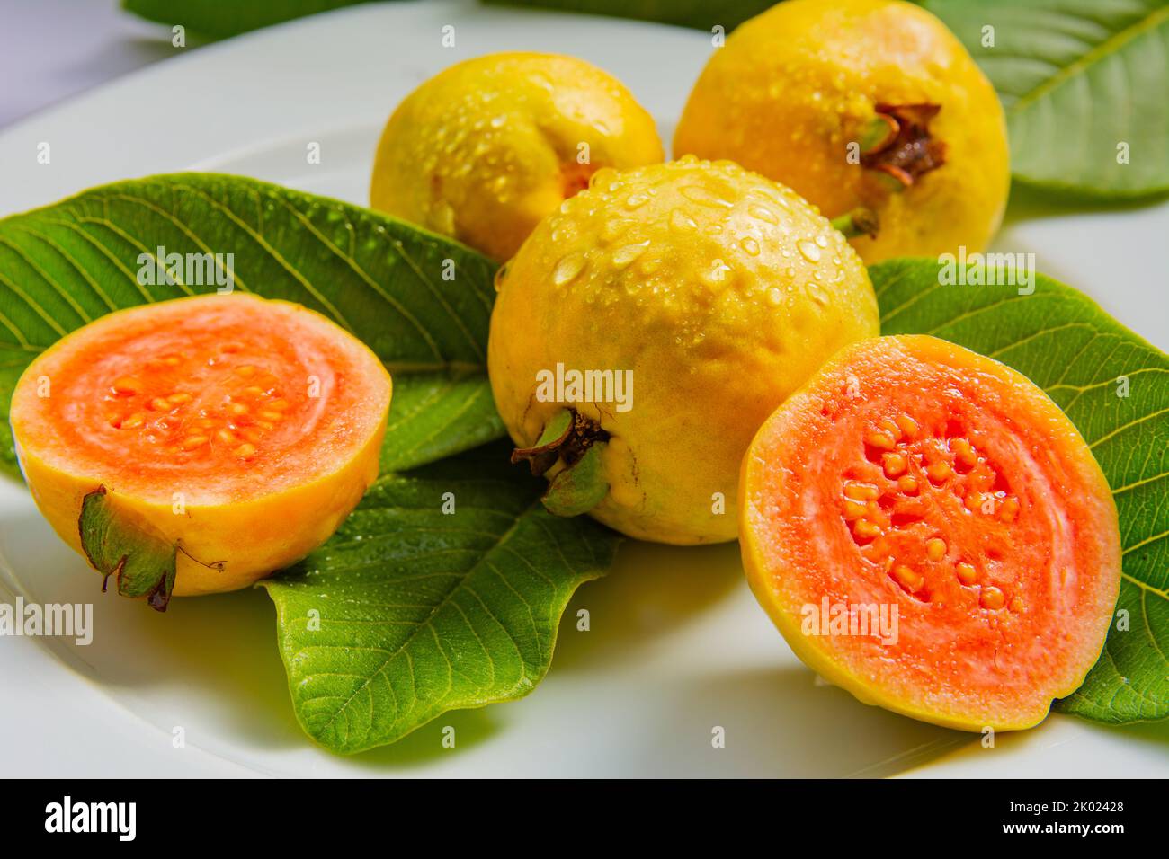 Ripe yellow fruits and leaves of guava on a white background. Beautiful ...