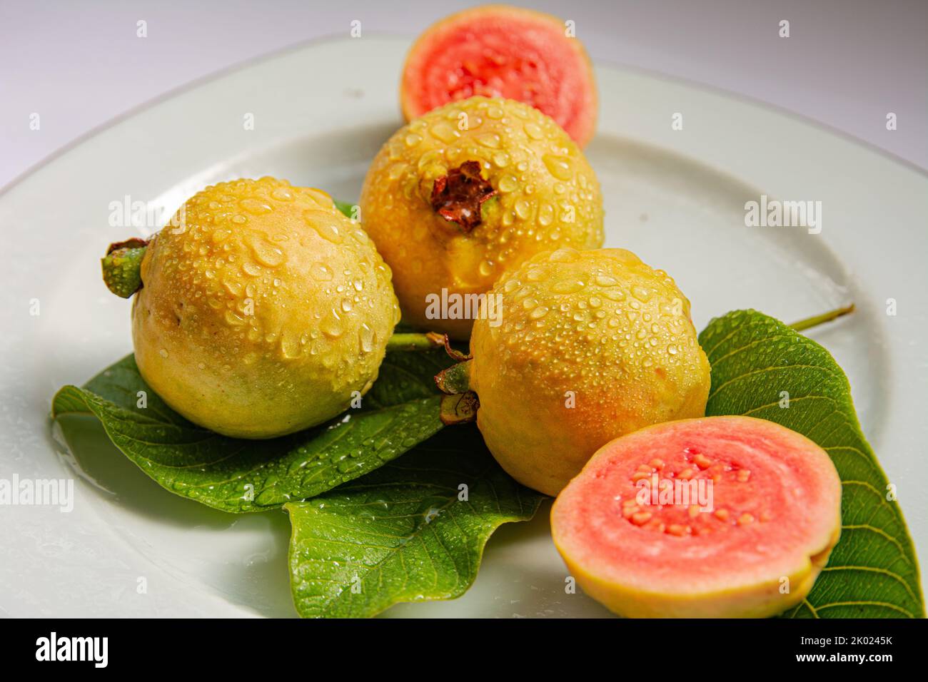 Ripe yellow fruits and leaves of guava on a white background. Beautiful ...