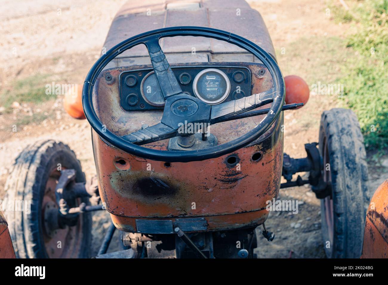 Old red vintage tractor with an open cab. photo of a rural tractor ...