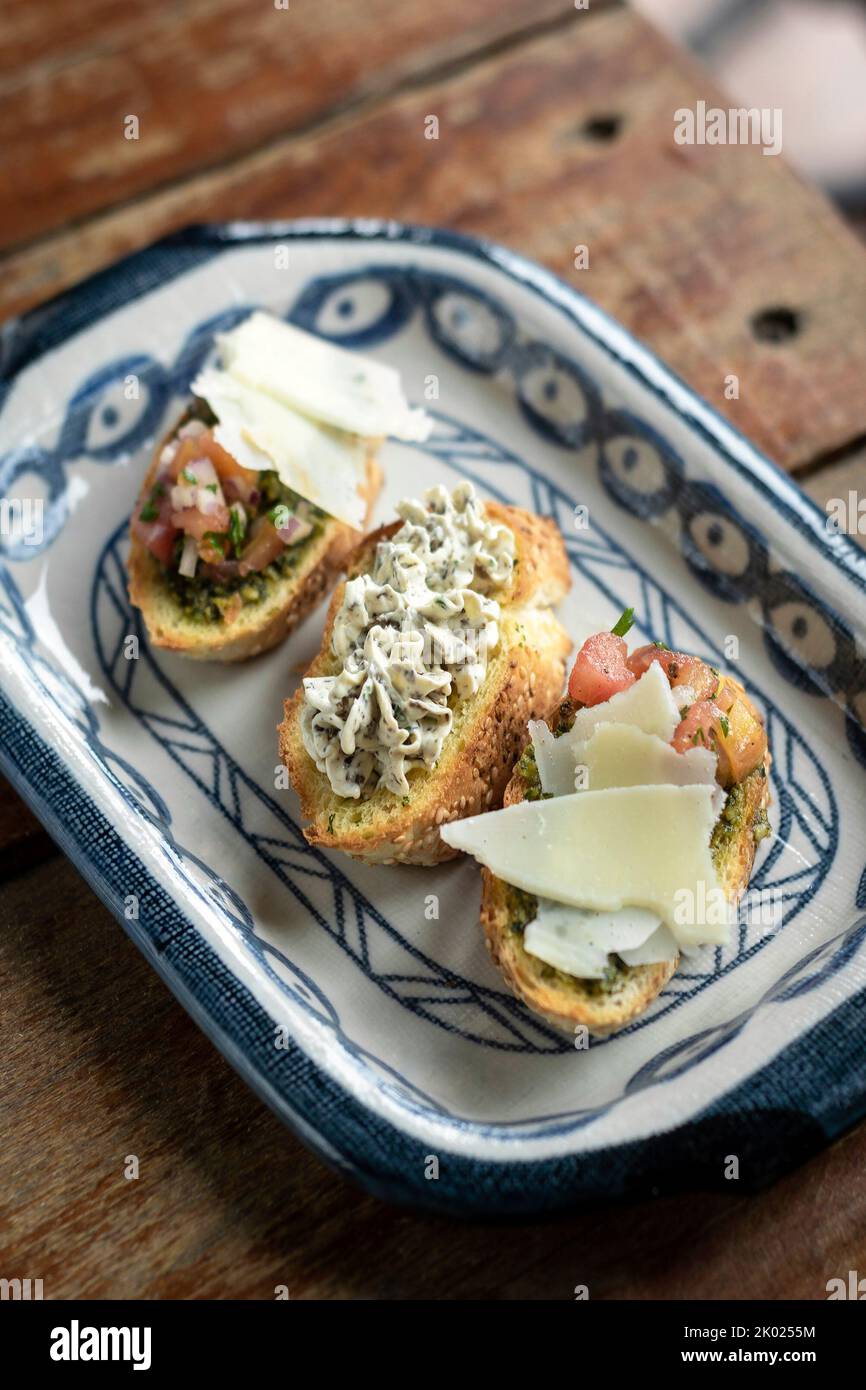 tapas with Bruschetta and creamed herb cheese on toast in rustic ...