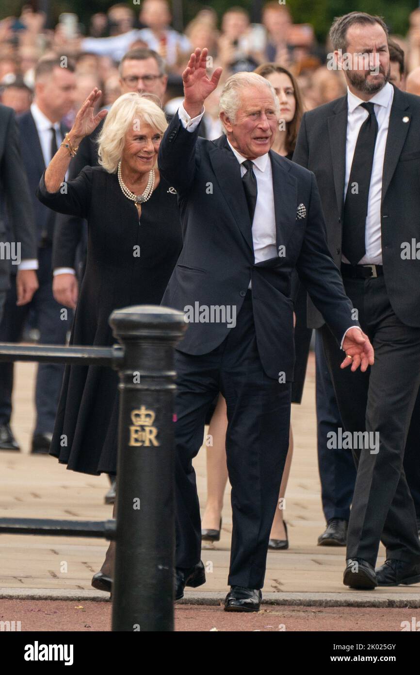 King Charles III and the Queen wave to the crowd outside Buckingham ...