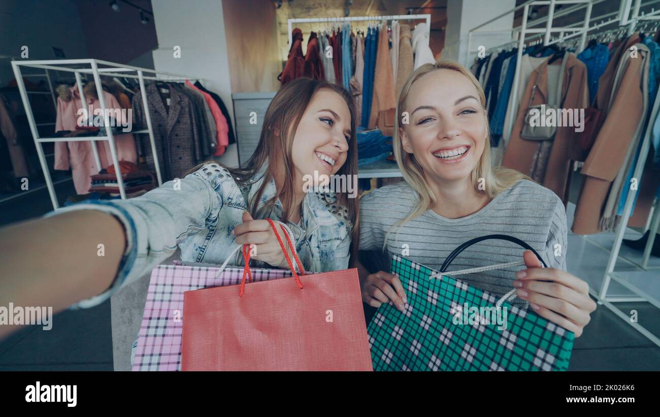 Point of view shot of two beautiful young women making selfie together ...